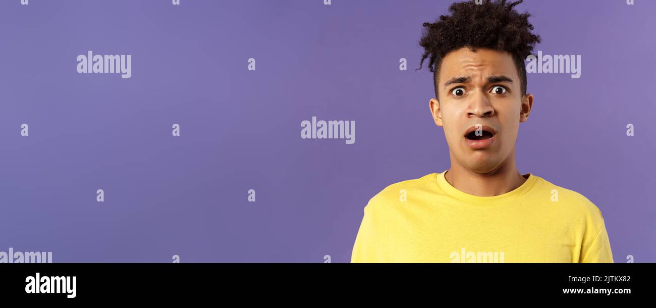 Close-up portrait of shocked, alarmed young man gasping, open mouth ...