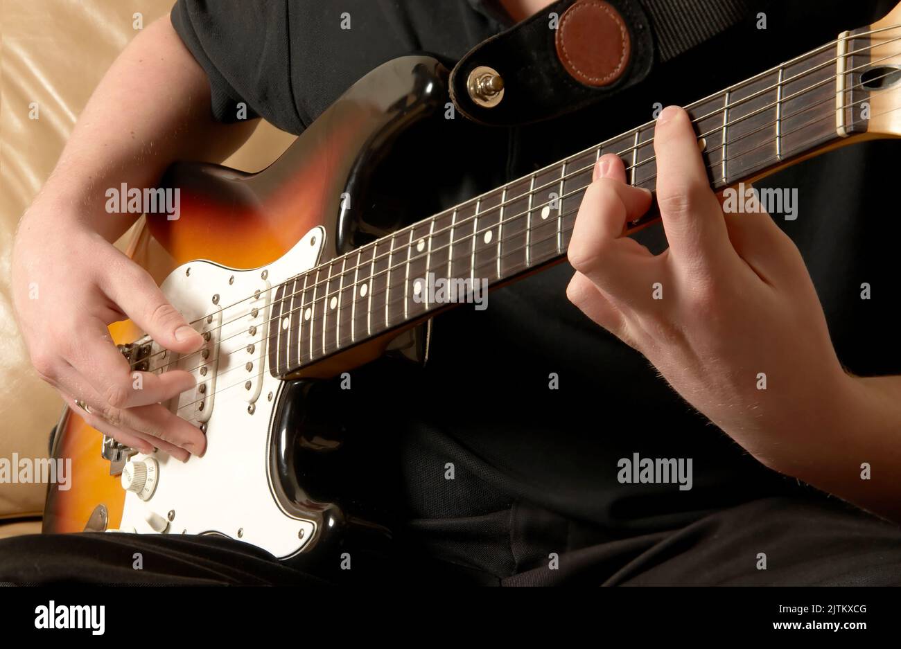 Close up of a guitar player strumming chords playing the electric ...