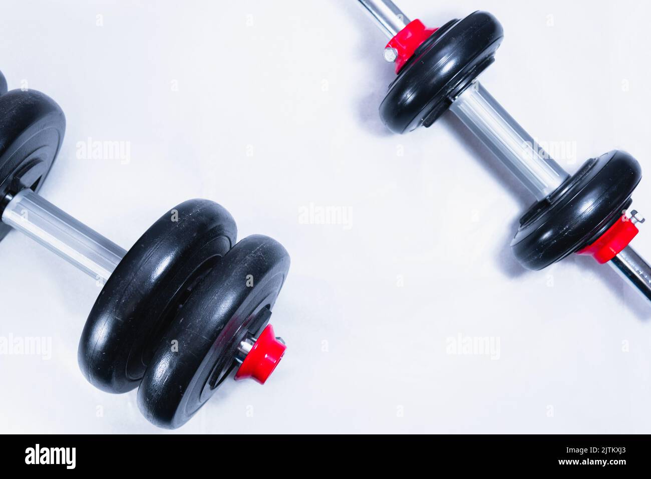 High quality photography. A pair of black dumbbells with red on a white ...