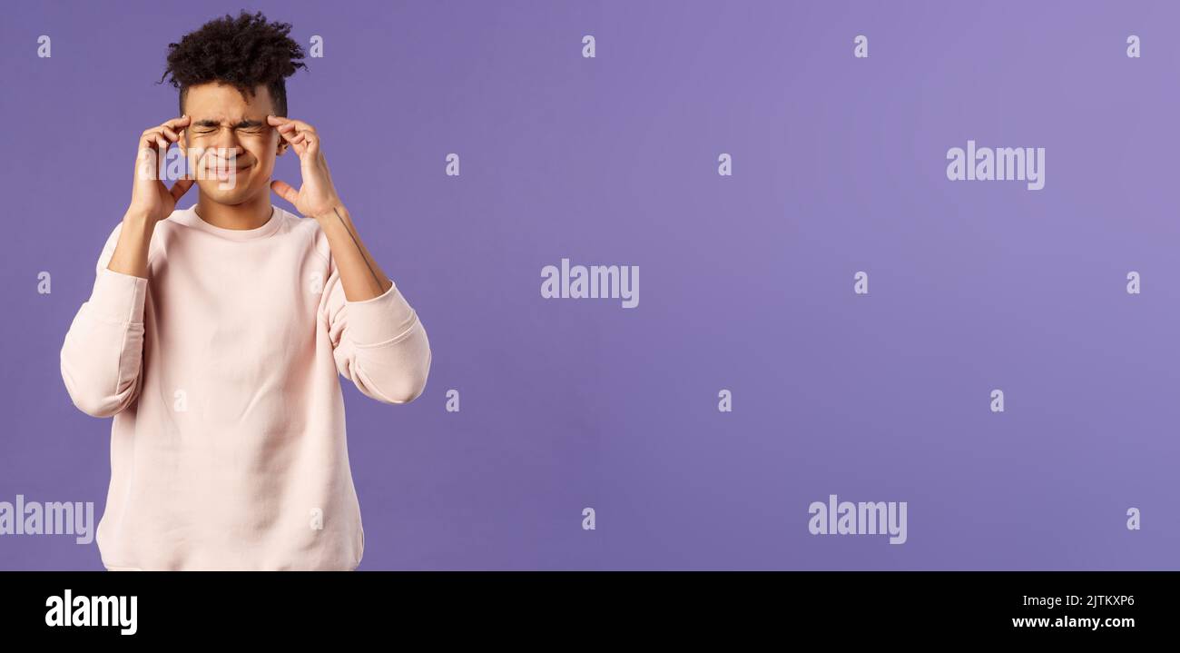 Portrait of intense, pressed young male student overworked, feel tired ...