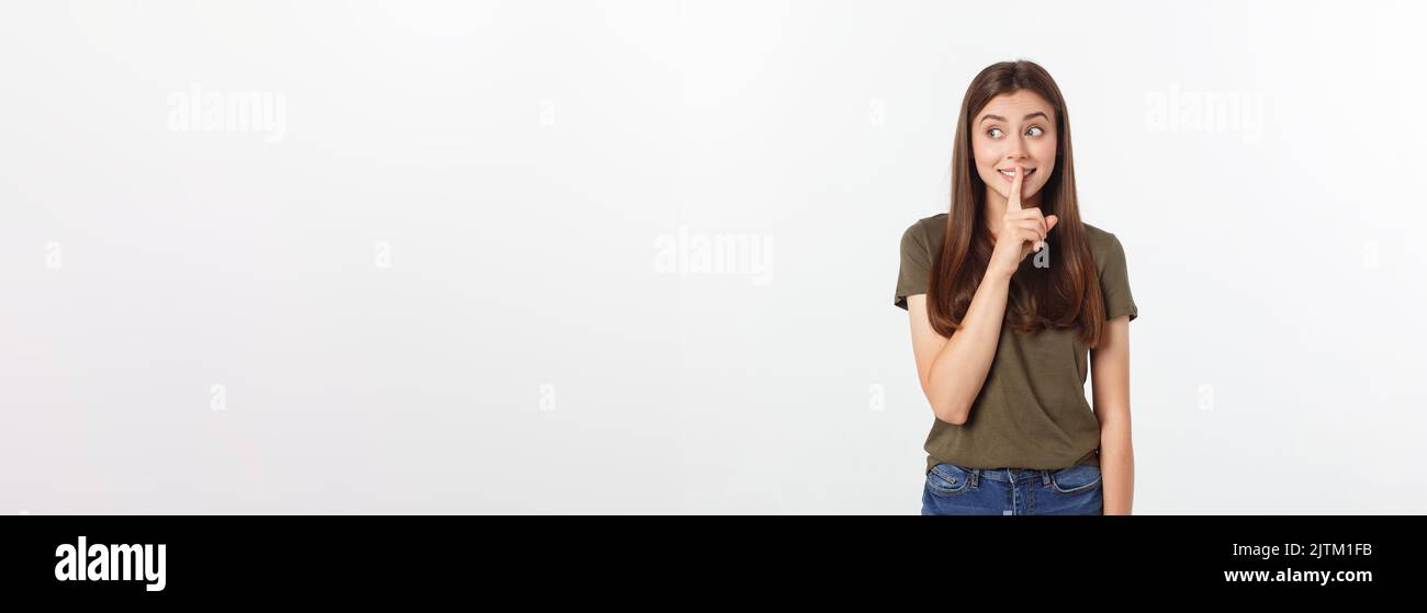 Beautiful woman showing finger over lips isolated on a white background ...