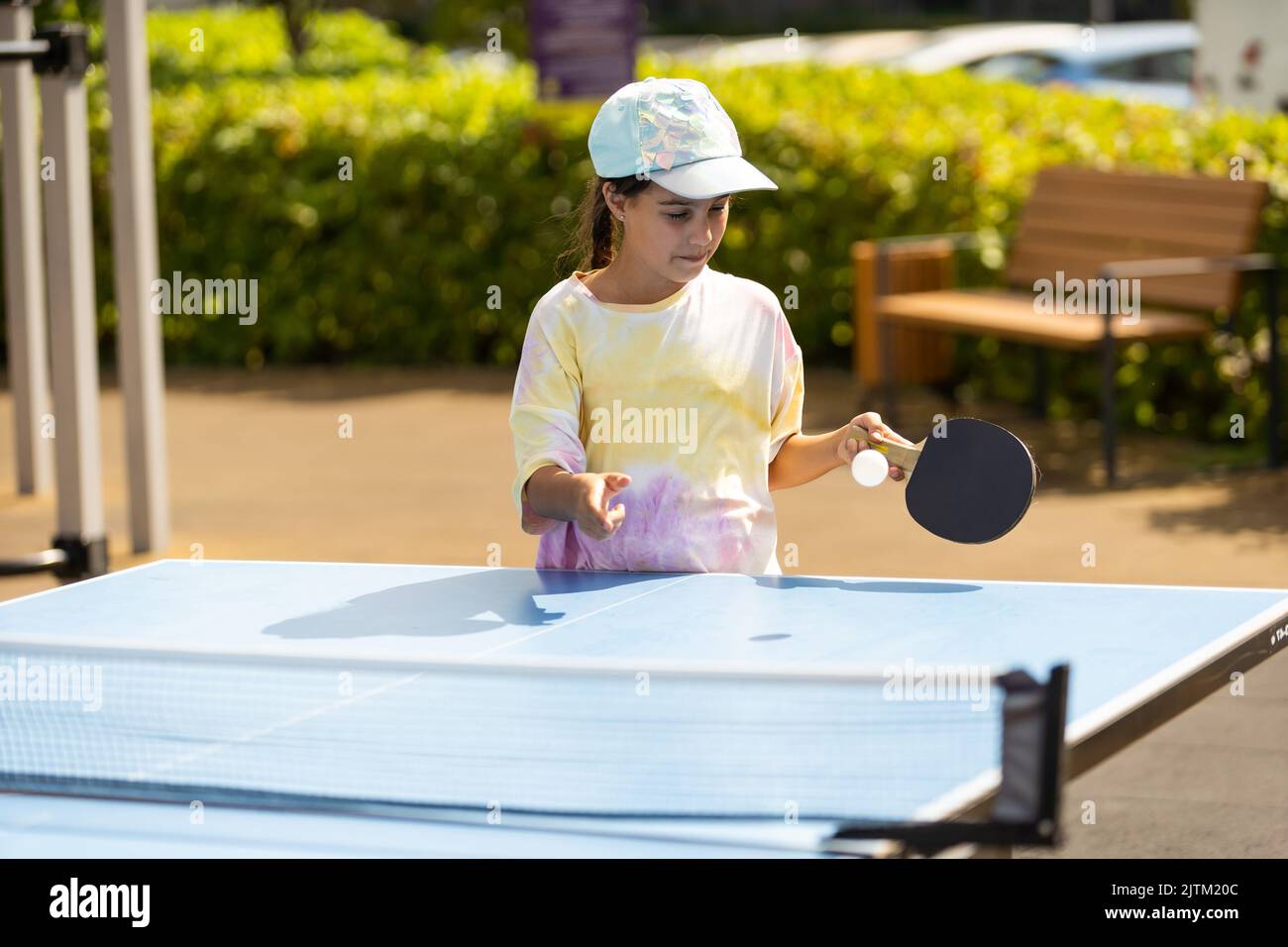 Little girl playing ping pong in park Stock Photo - Alamy