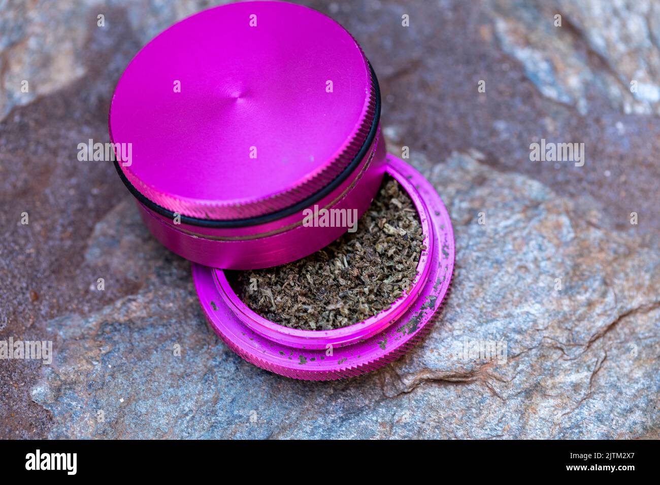 Marijuana ground inside the grinder to make joint Stock Photo - Alamy