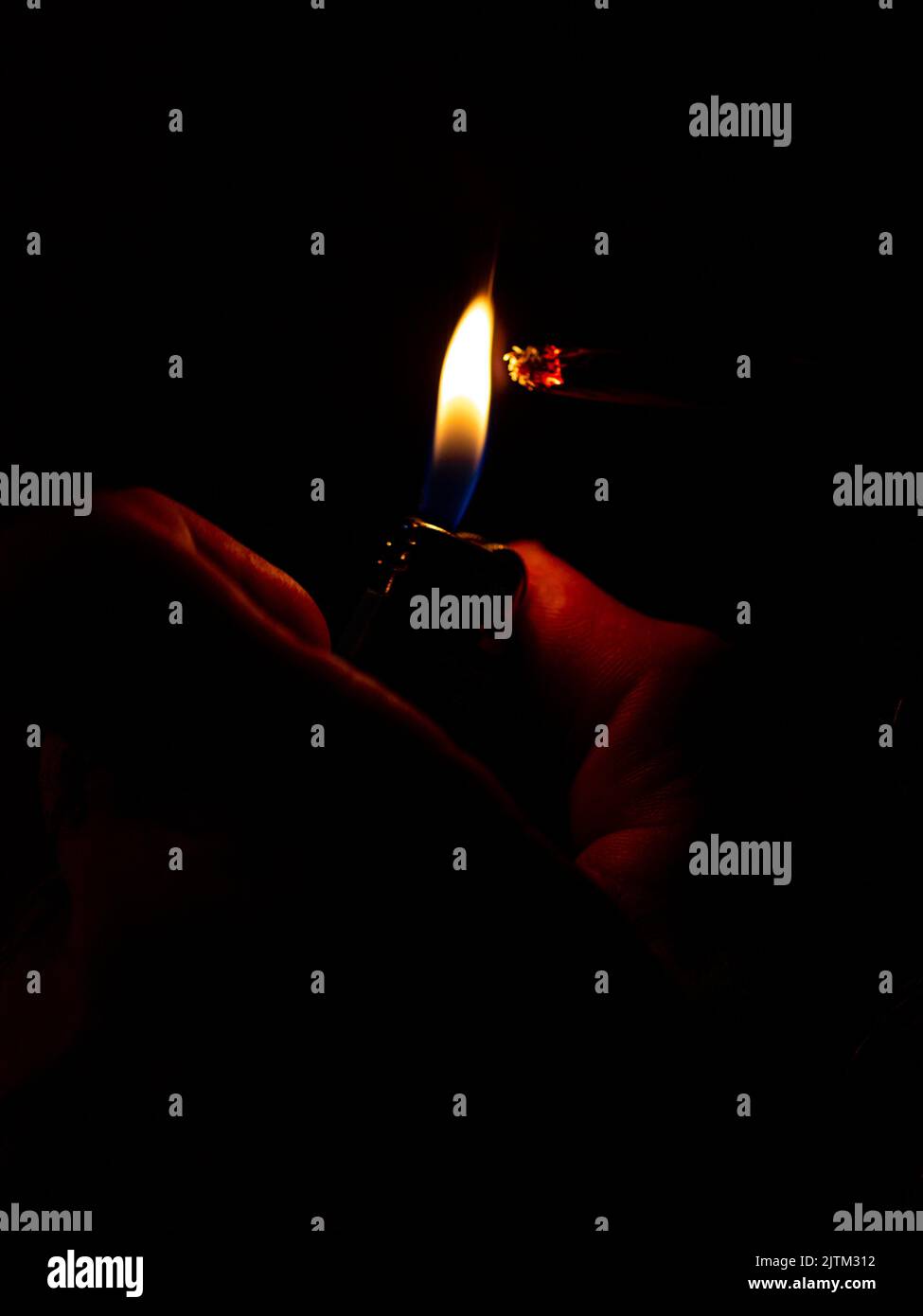 Lighting a marijuana joint, smoke Stock Photo - Alamy