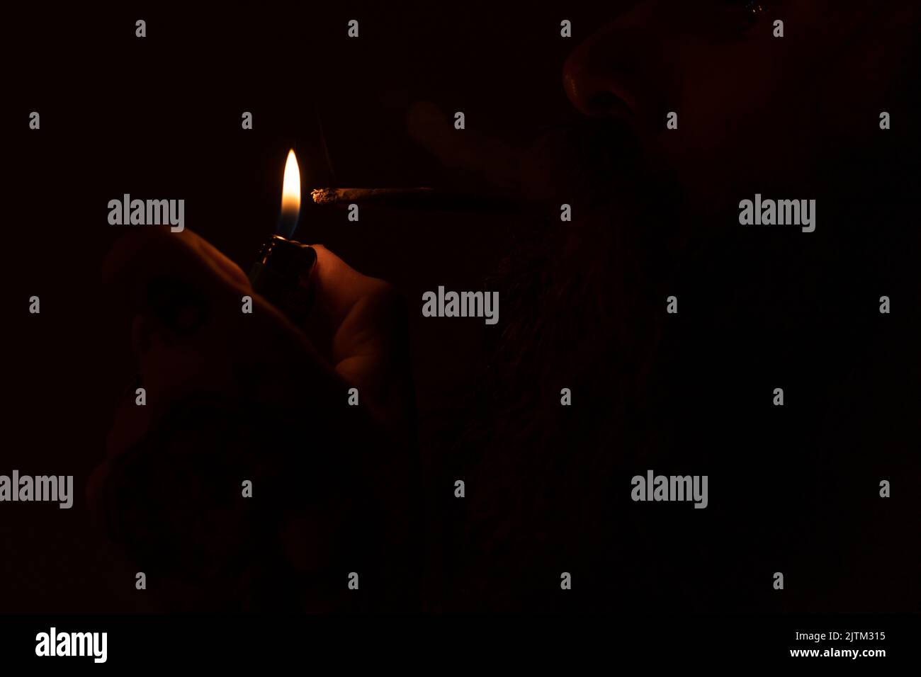 Lighting a marijuana joint, smoke Stock Photo - Alamy