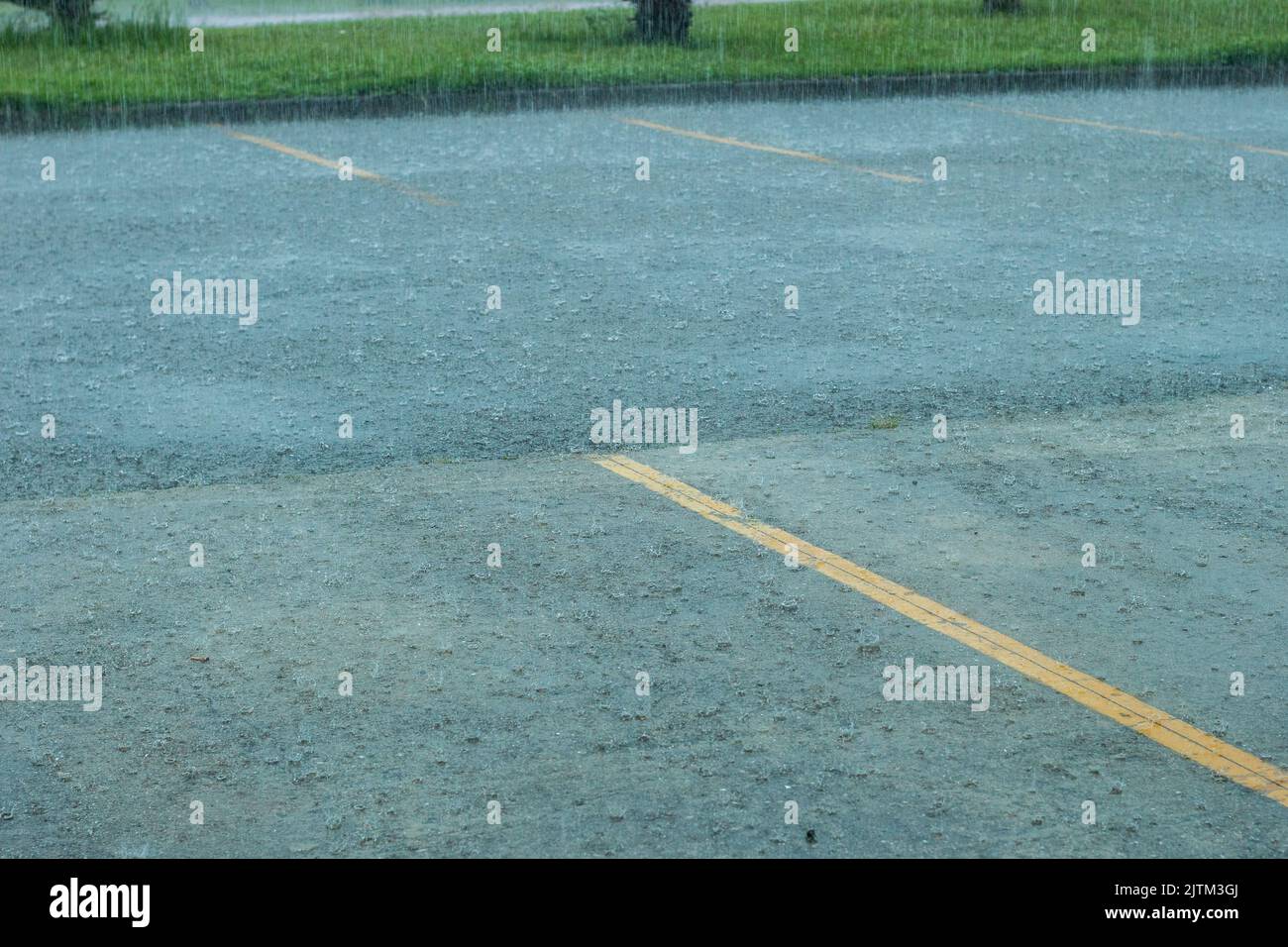 rain falling on the asphalt with yellow lines on the ground in Rio de ...