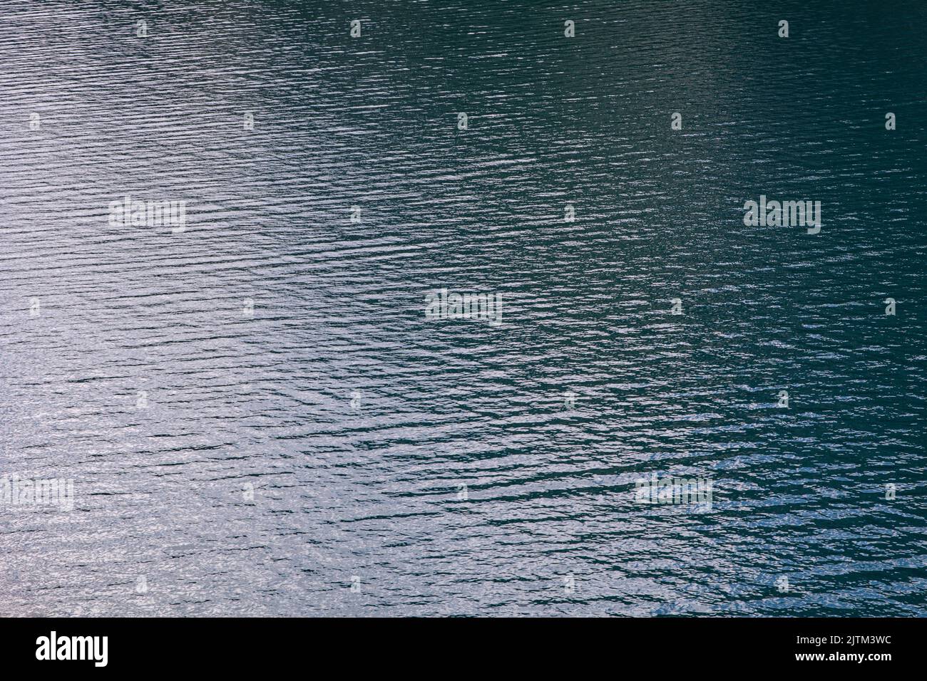 Infinite background of water waves in lake. Blue to black colors ...