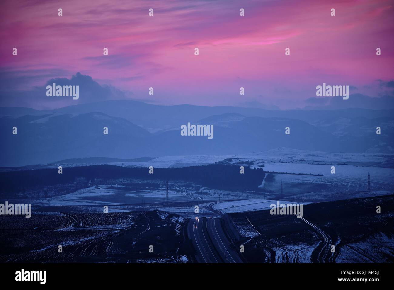 A beautiful view of the Pink sunset over the Transylvanian highway at ...