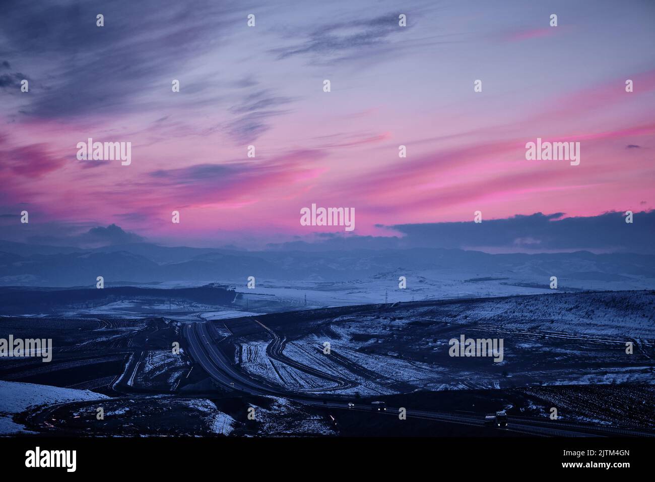 A beautiful view of the Pink sunset over the Transylvanian highway at ...