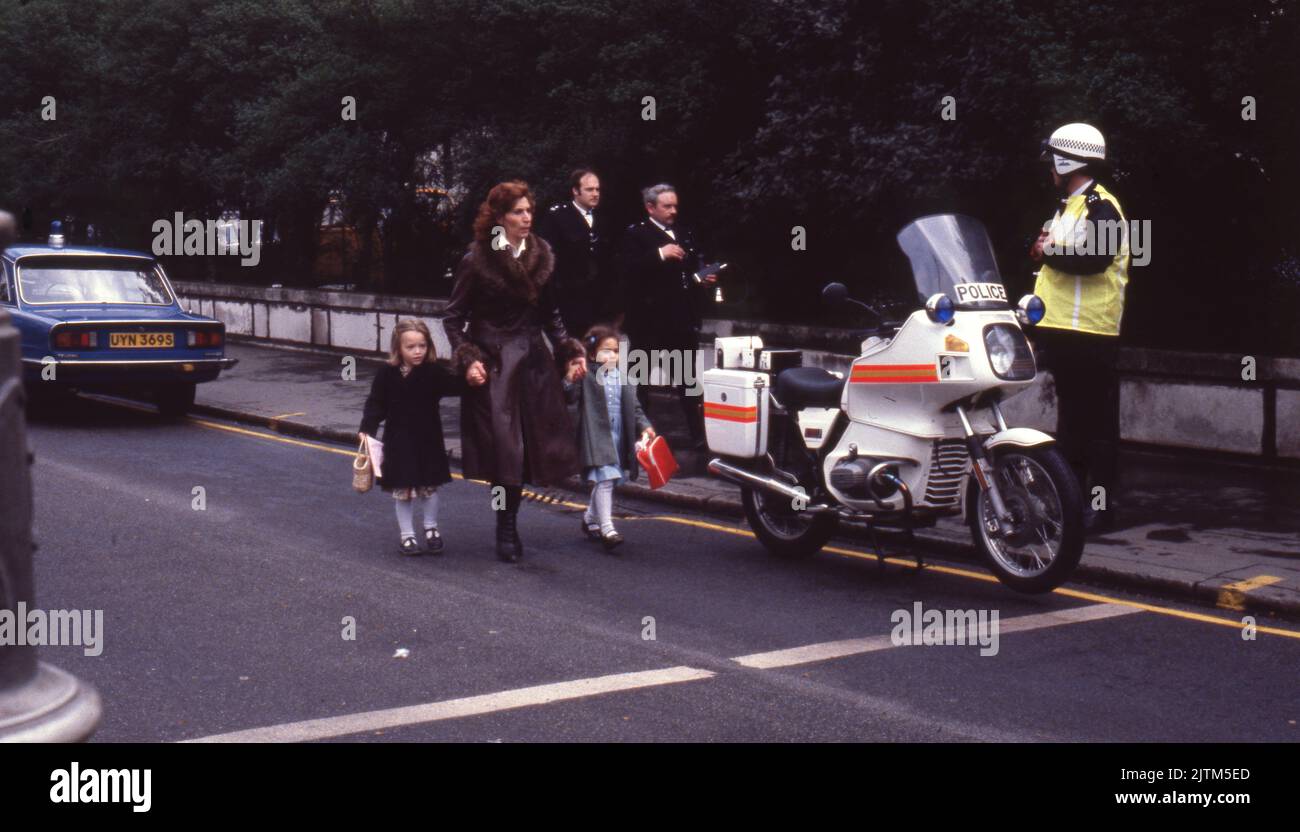 April 30, 1980, London, United Kingdom: Woman walking with two small ...