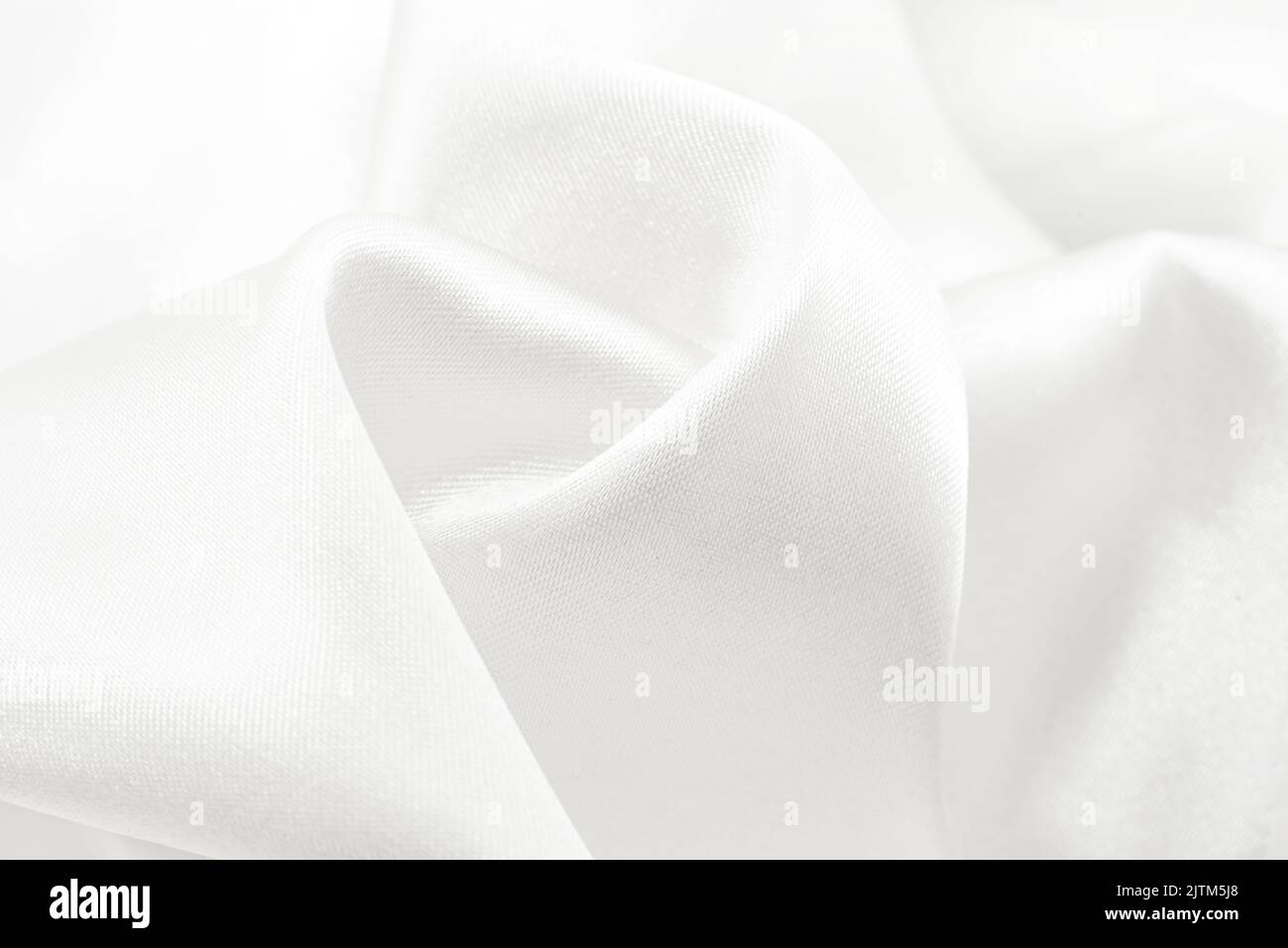 A twisted piece of white fabric. White material or texture with waves ...