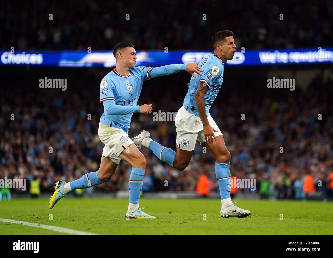 Manchester City's Joao Cancelo (right) celebrates scoring their side's ...