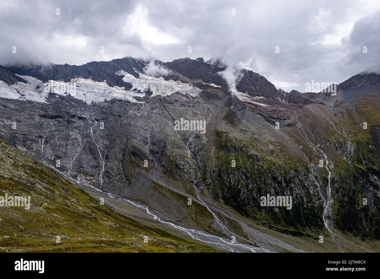 Impressive alpine view of high peaks in summer Stock Photo - Alamy