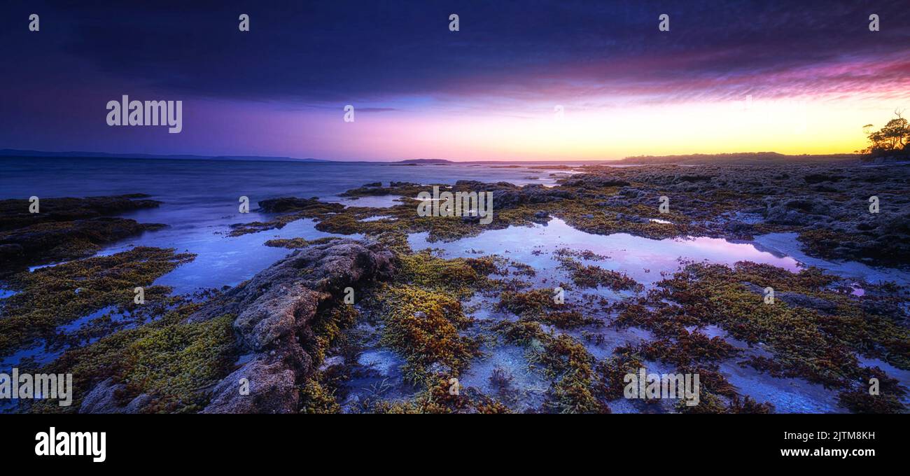 A landscape with ocean waves hitting a rocky coast Stock Photo - Alamy
