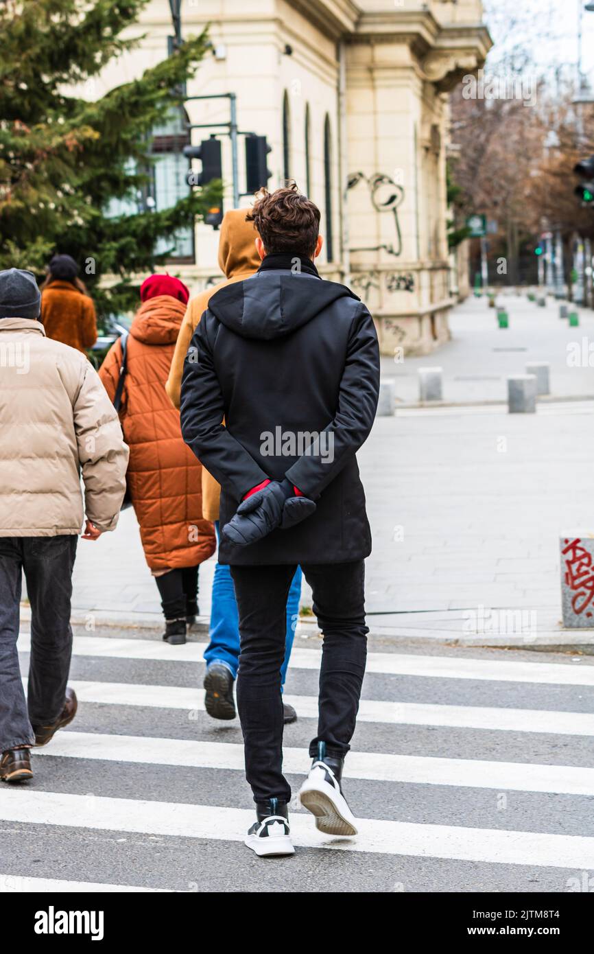 People and tourists wander the streets of the Bucharest Old Town ...