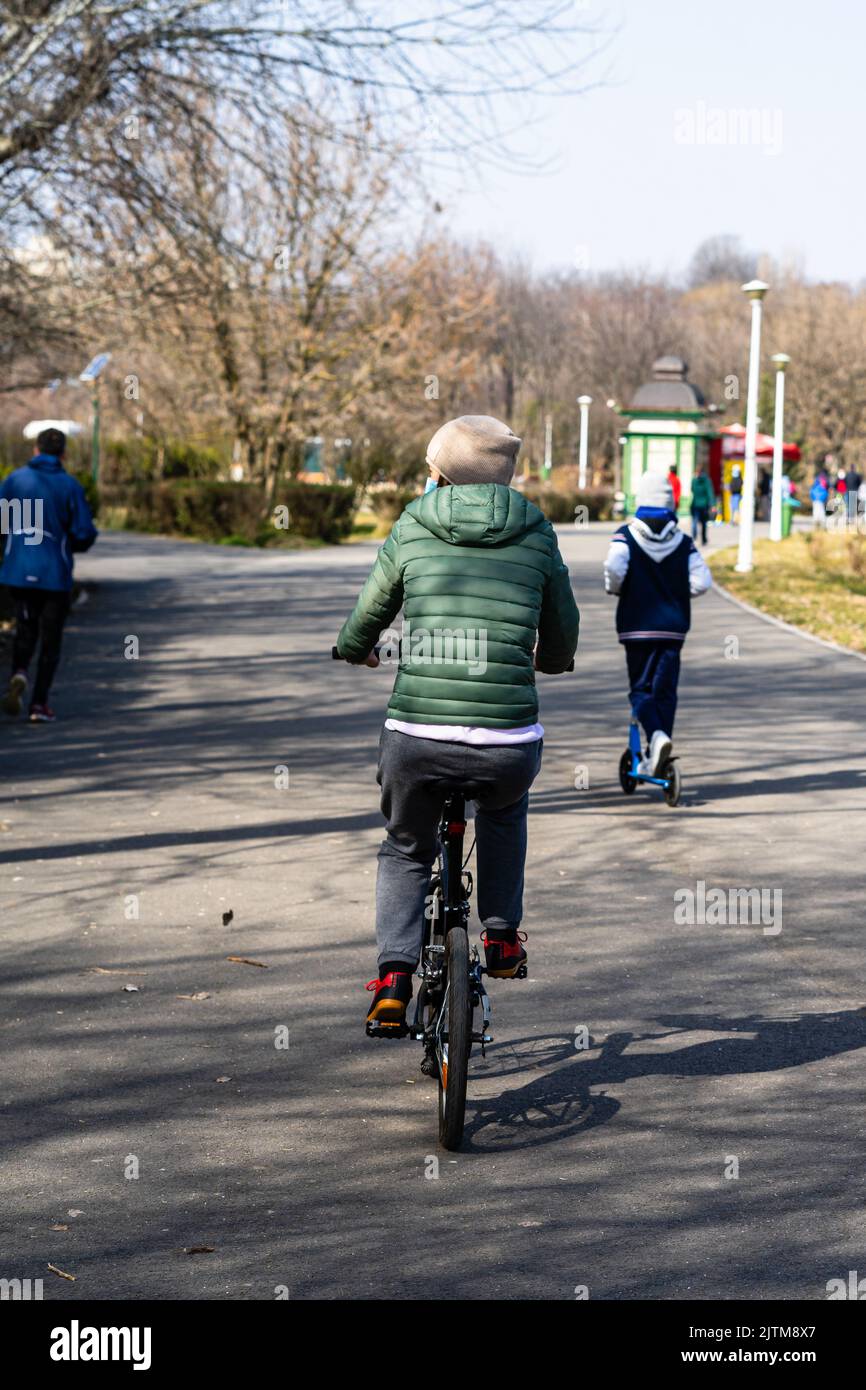 Riding a bicycle on the city streets. Commute to work in Bucharest ...