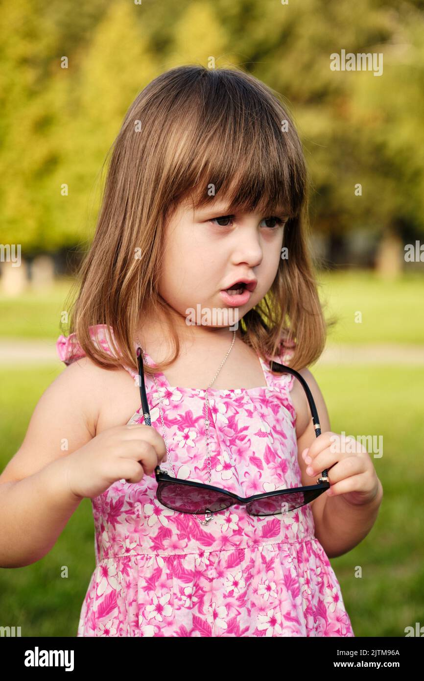 Little girl wearing mom's sunglasses. Portrait of a sweet baby girl who ...