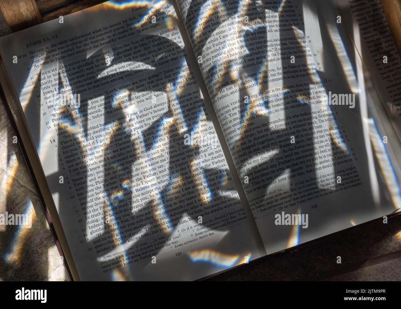 Open Bible with words in darkness and others in light making it hard to ...