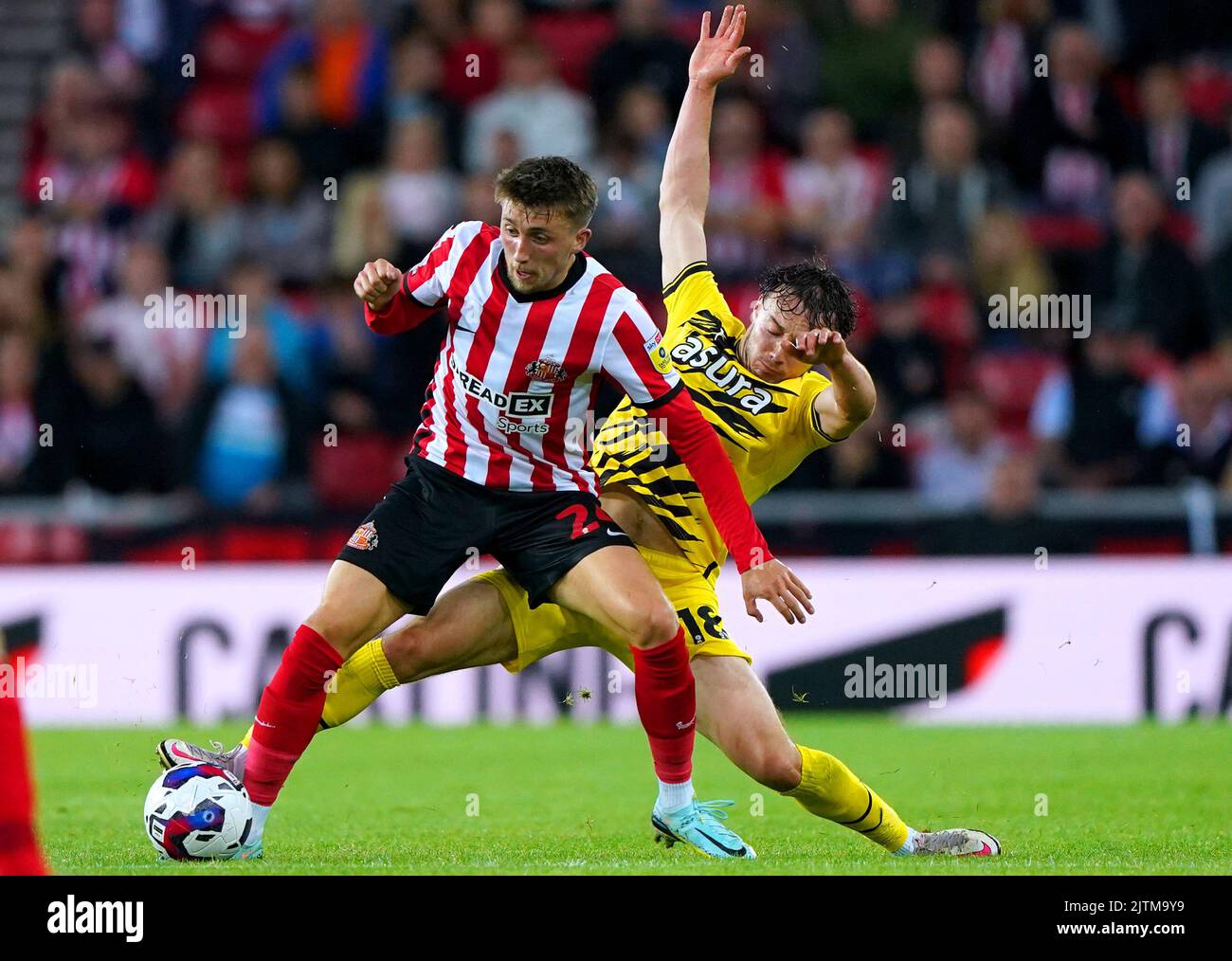 Sunderland's Dan Neil (left) and Rotherham United's Ollie Rathbone ...