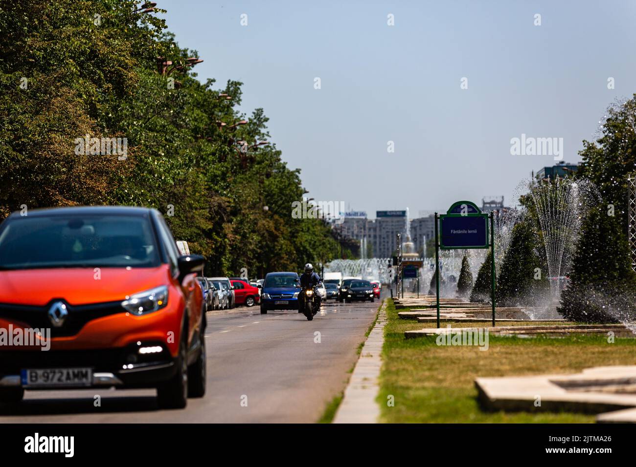 Biker on a motorcycle in traffic at rush hour in downtown area of the ...