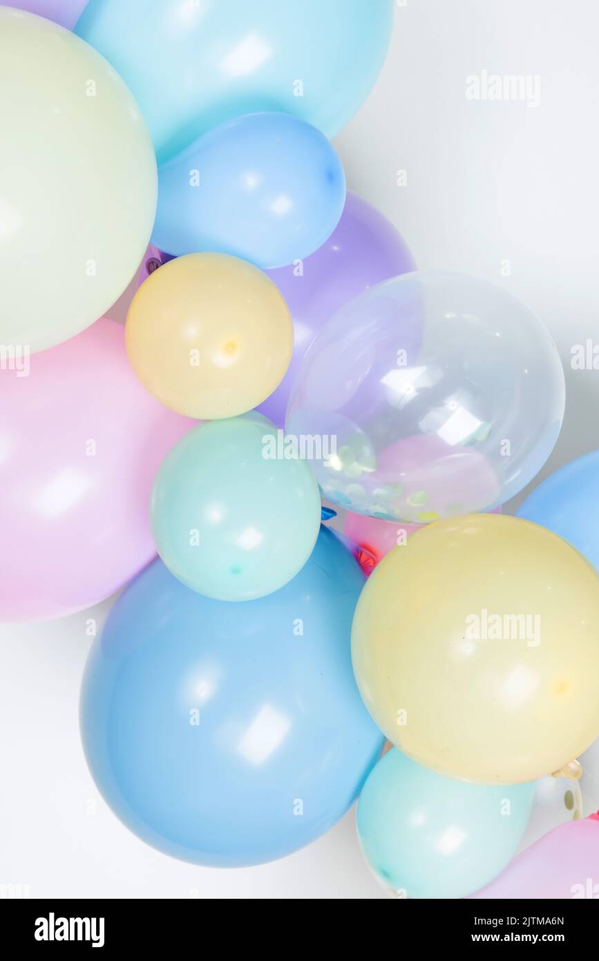 A close up image of a soft pastel balloon garland against a white ...