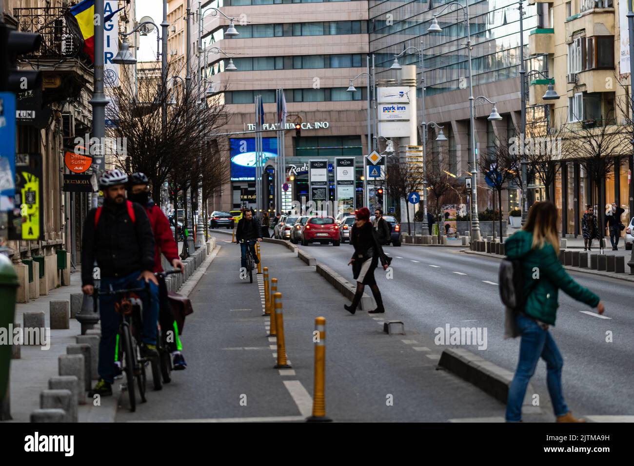 People and tourists wander the streets of the Bucharest Old Town ...