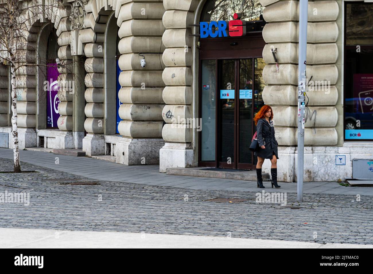 People and tourists wander the streets of the Bucharest Old Town ...