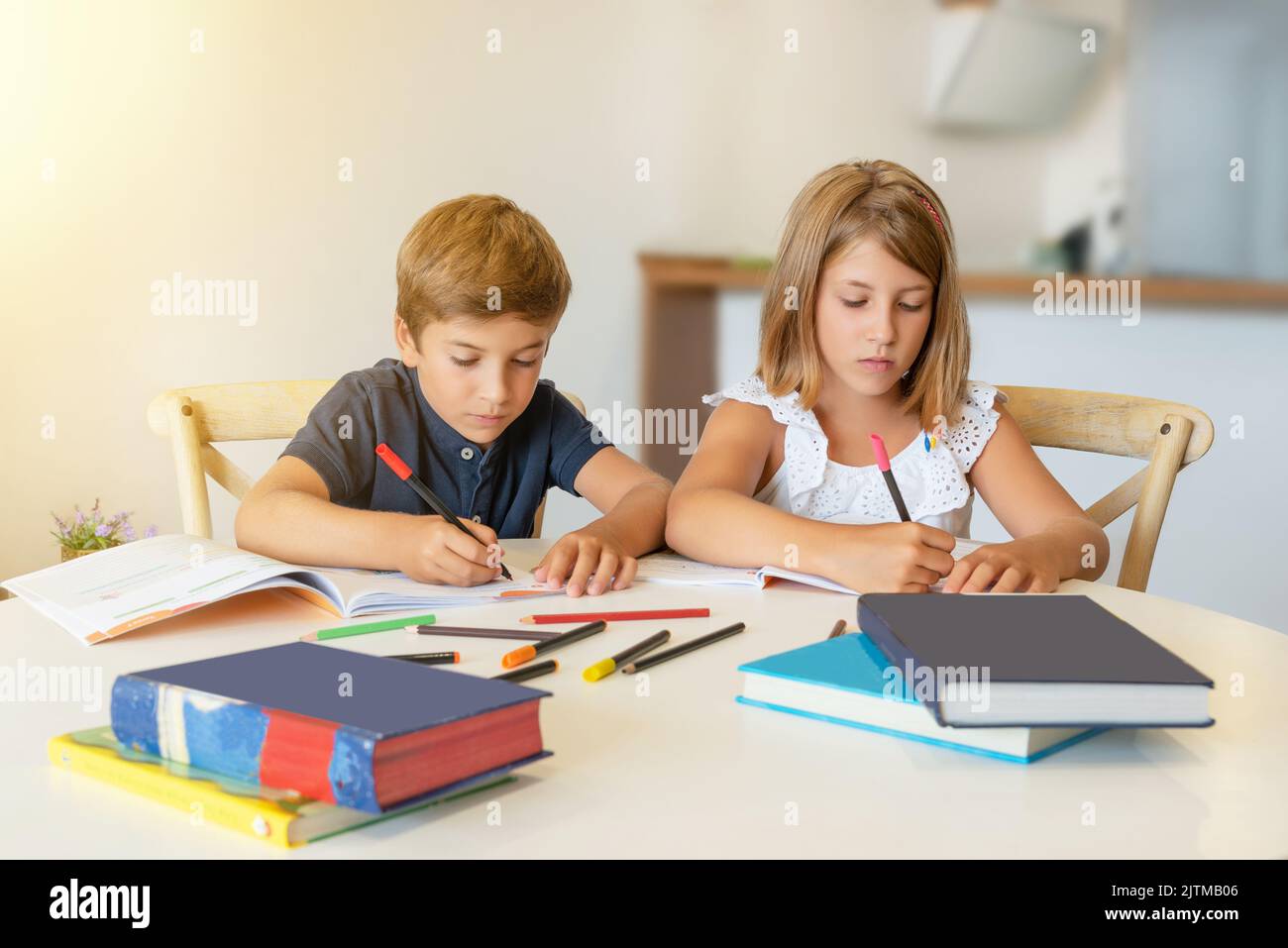 Children concentrating on drawing and studying at home. Kids doing ...