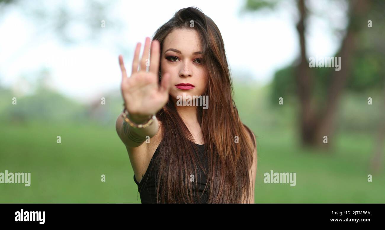 Annoyed attracrtive woman rejecting with hand and finger telling viewer ...