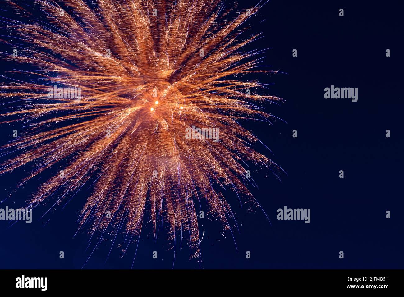 An explosion of bright single fireworks, against the background of the ...