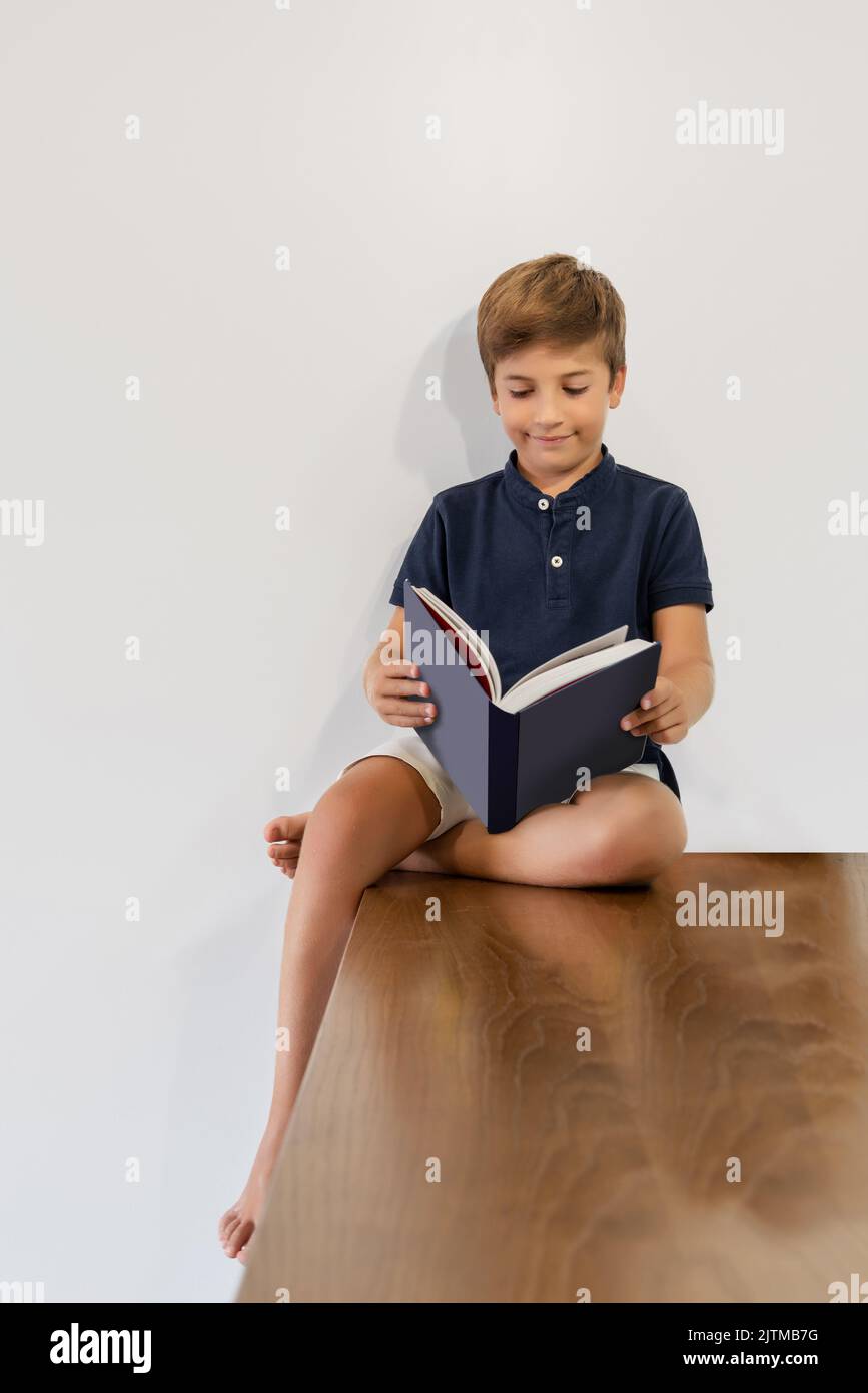 Child sitting reading a book. Learning and studying to pass the ...