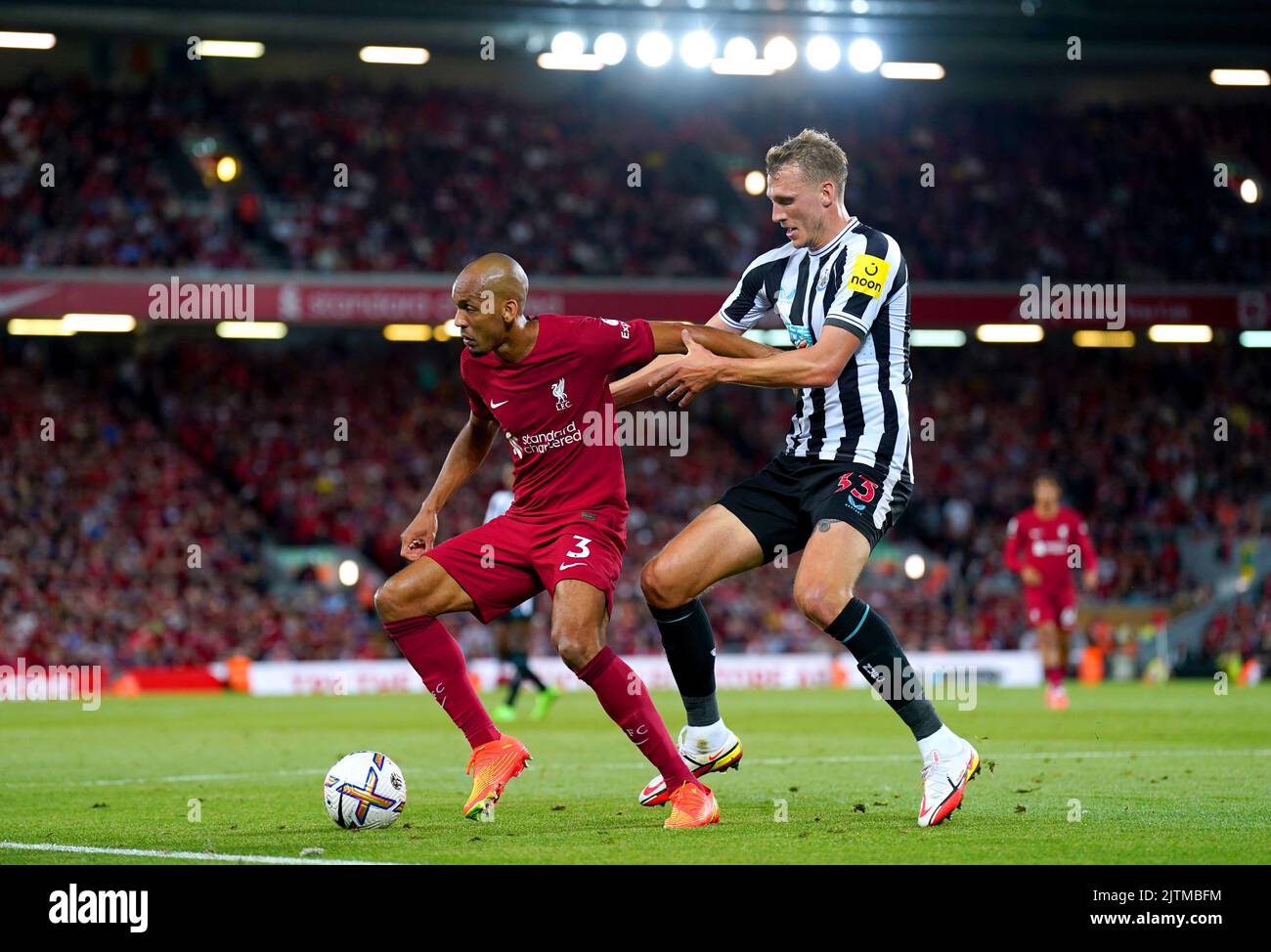 Liverpool's Fabinho (left) and Newcastle United's Dan Burn battle for ...