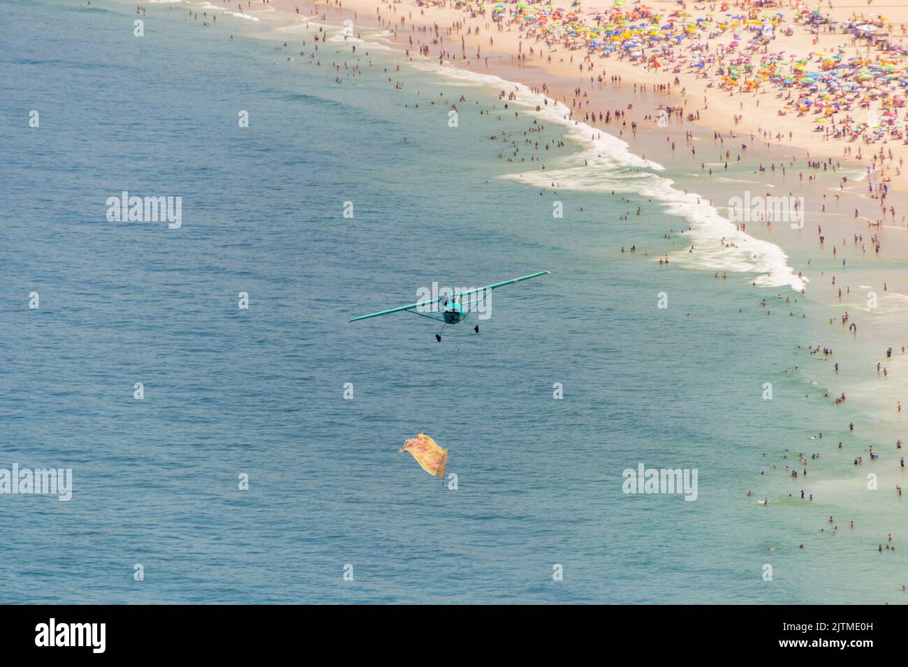 small plane flying over copacabana beach in Rio de Janeiro Brazil Stock ...