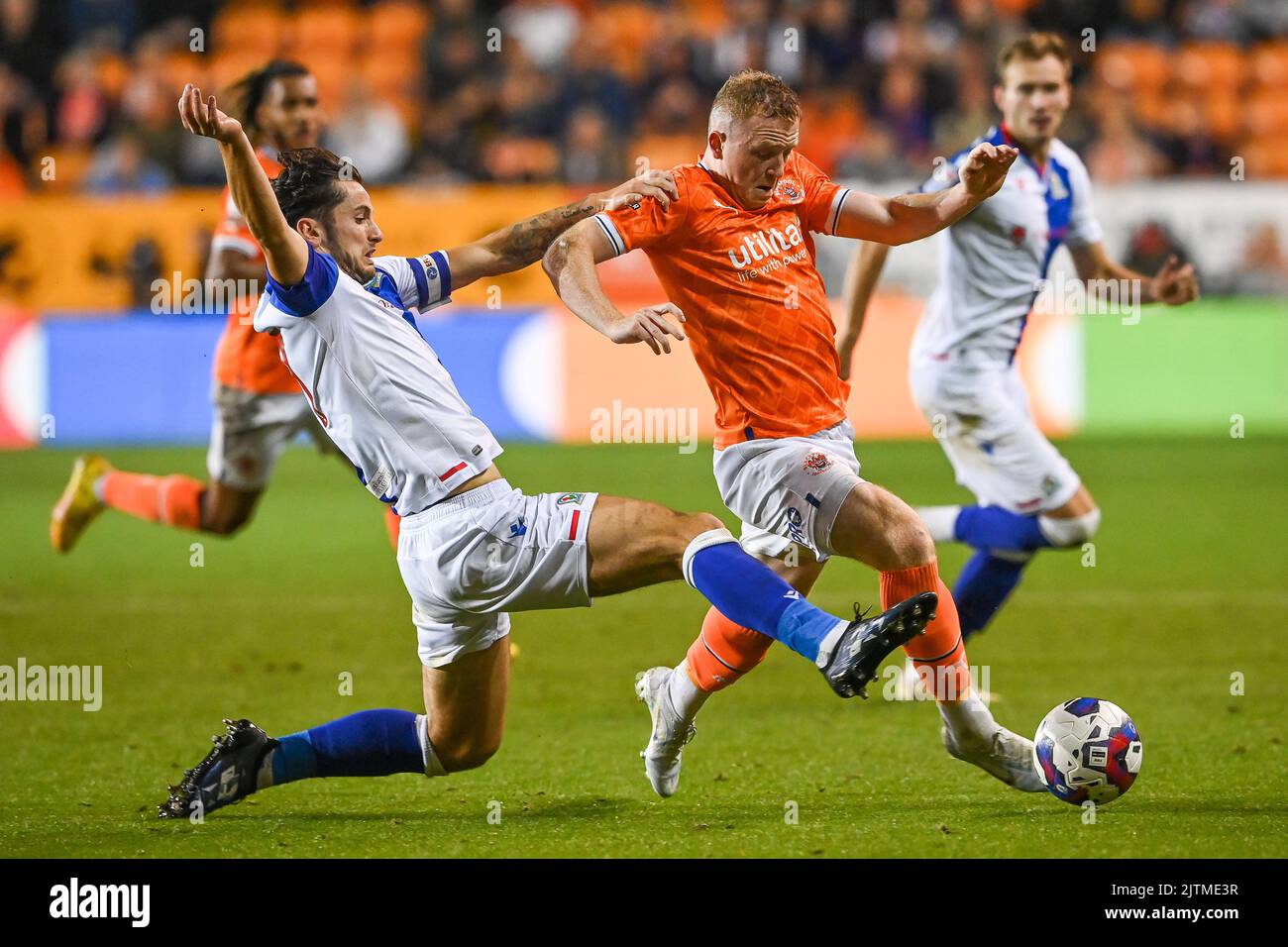 Shayne Lavery #19 of Blackpool evades the tackle Lewis Travis #27 of ...