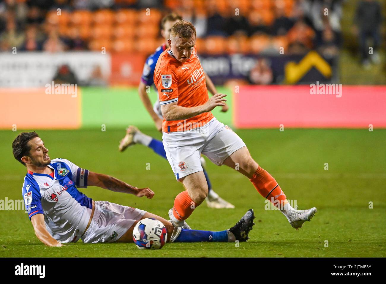 Shayne Lavery #19 of Blackpool evades the tackle Lewis Travis #27 of ...
