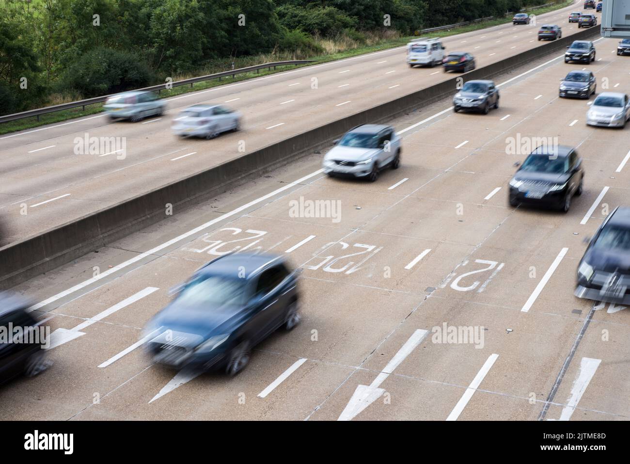 Cars and other vehicles moving along a British motorway at speed in ...