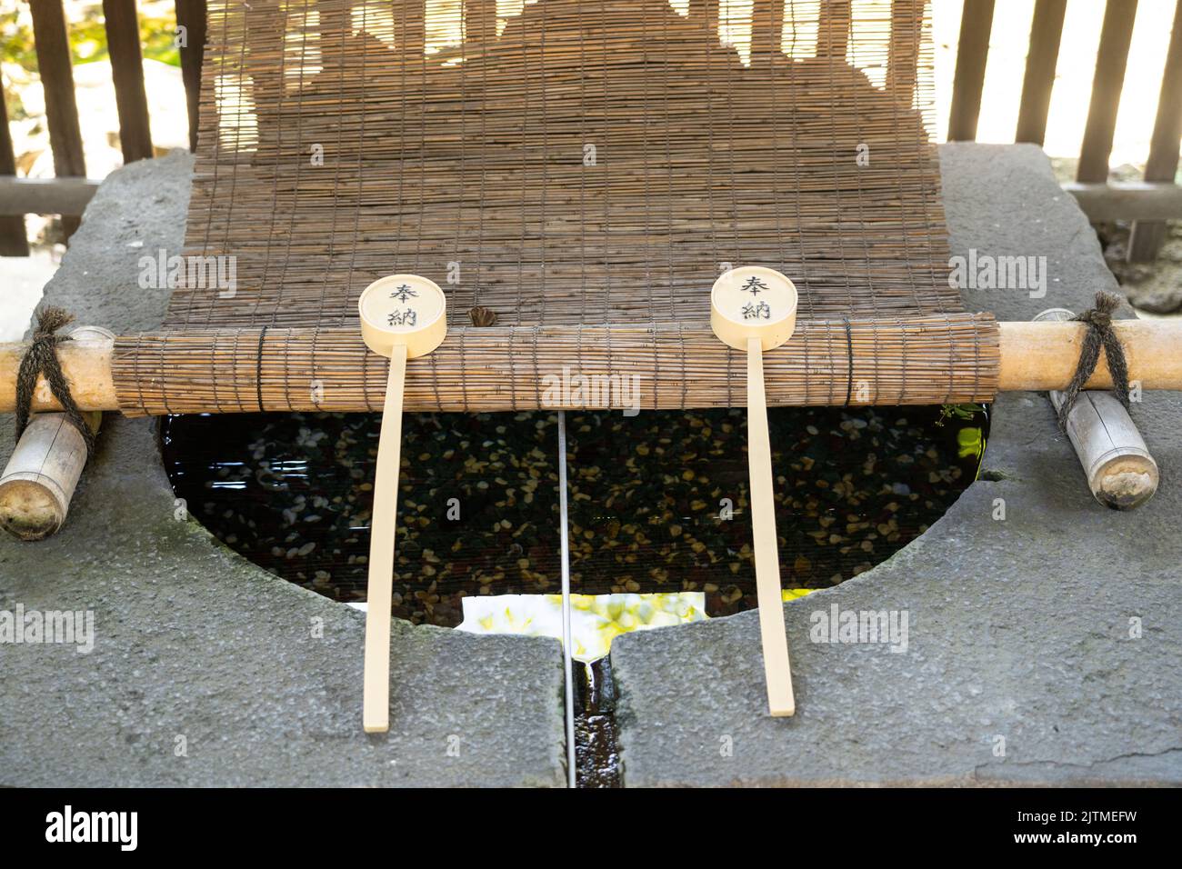 The temizuya for ritual purification at the Mimeguri-jinja Shrine, in ...