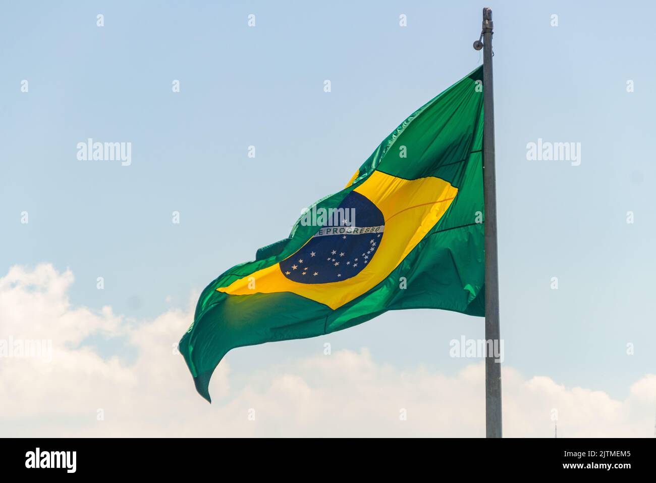 Brazilian flag outdoors with blue background in Rio de Janeiro Brazil ...