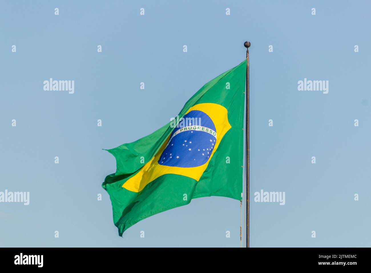 Brazilian flag flying with blue sky background in Rio de Janeiro Stock ...