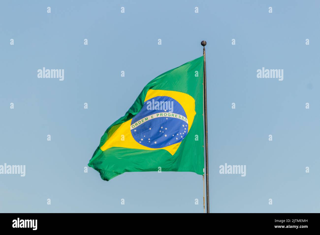 Brazilian flag flying with blue sky background in Rio de Janeiro Stock ...