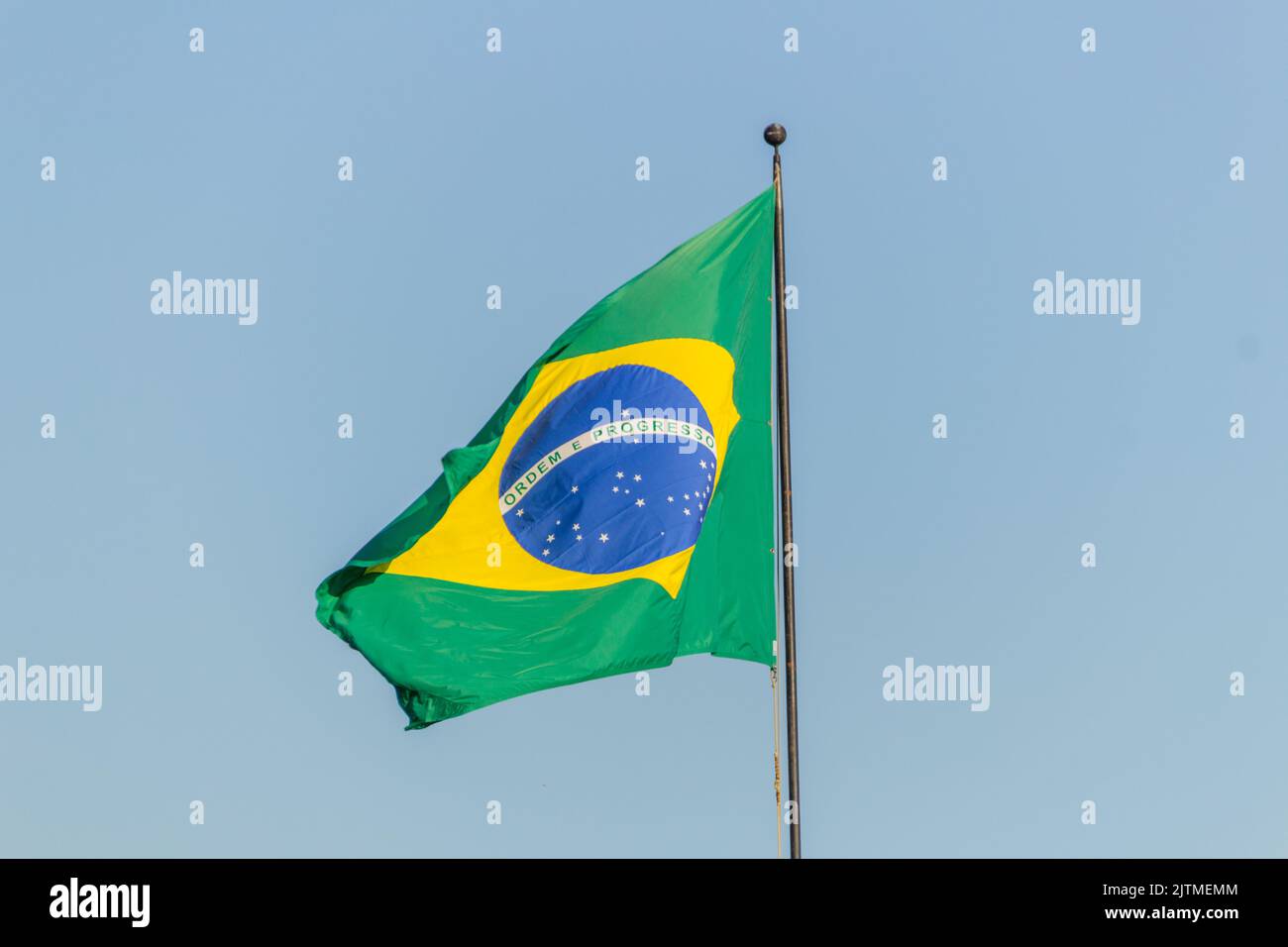 Brazilian flag flying with blue sky background in Rio de Janeiro Stock ...