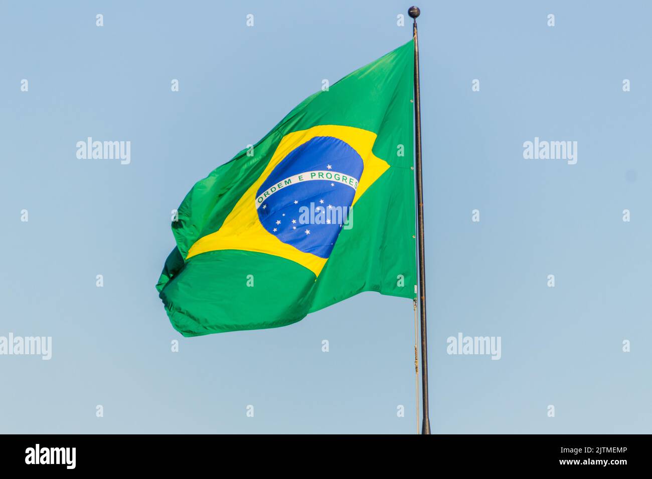 Brazilian flag flying with blue sky background in Rio de Janeiro Stock ...