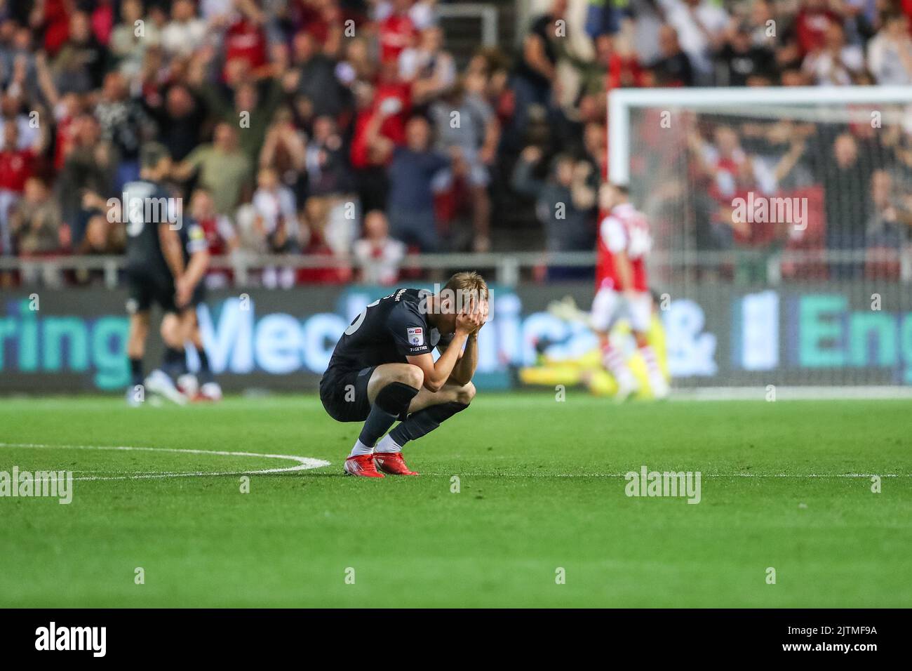 Pat Jones #26 of Huddersfield Town looks dejected as Antoine Semenyo ...