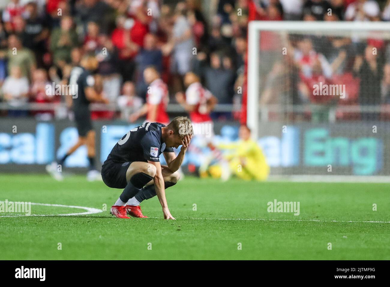 Pat Jones #26 of Huddersfield Town looks dejected as Antoine Semenyo ...