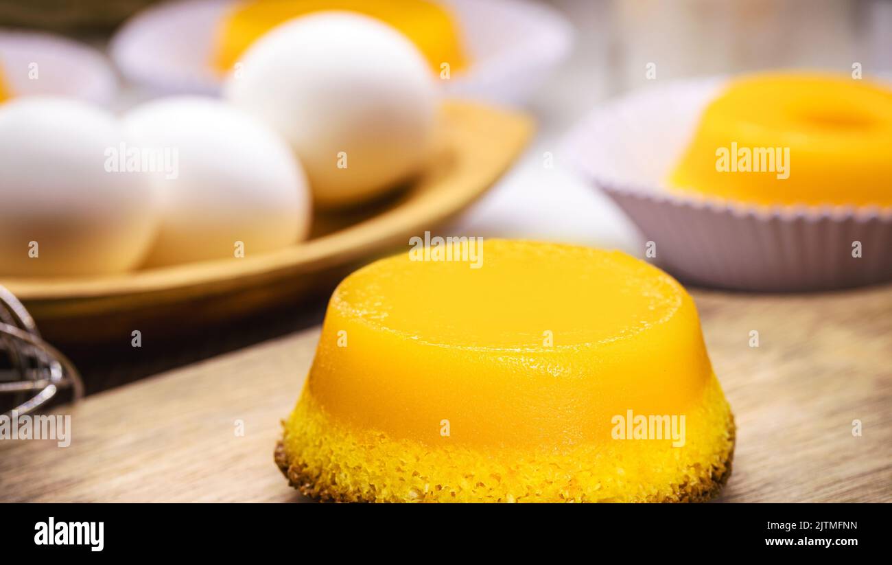 Quindim or Brisa do Lis, tasty dessert made with eggs in the background ...
