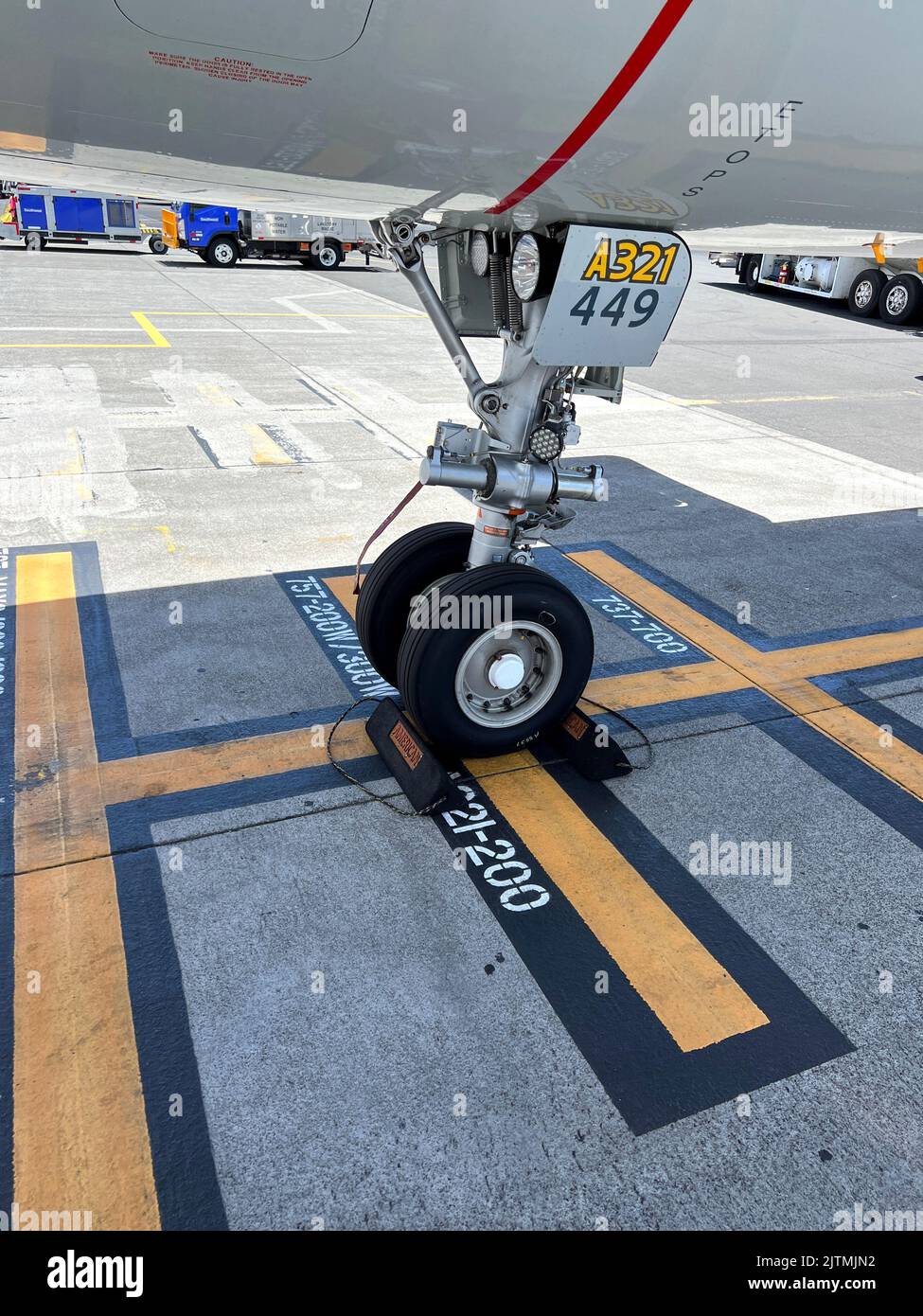 Wheels of an Airbus A321 plane held in place by chocks while parked at ...