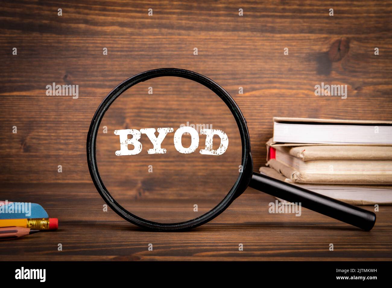 Byod concept. Magnifying glass with text on wooden office table Stock ...