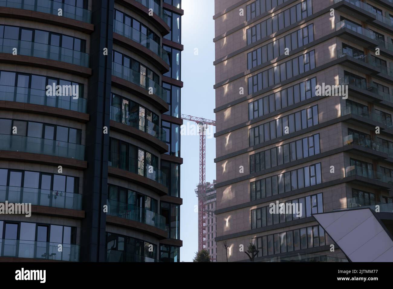 Residential building construction with a tower crane between the ...
