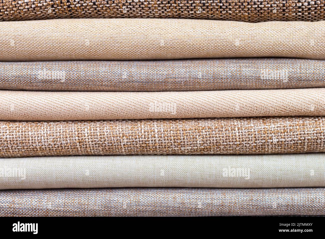 Pile of folded colorful textile. Heap of cloth fabric Stock Photo - Alamy