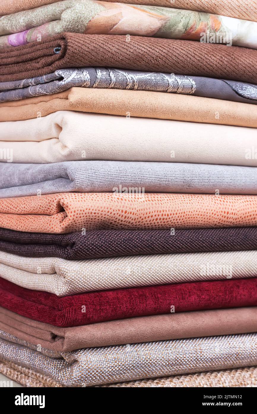 Pile of colorful folded textile. Heap of cloth fabric Stock Photo - Alamy